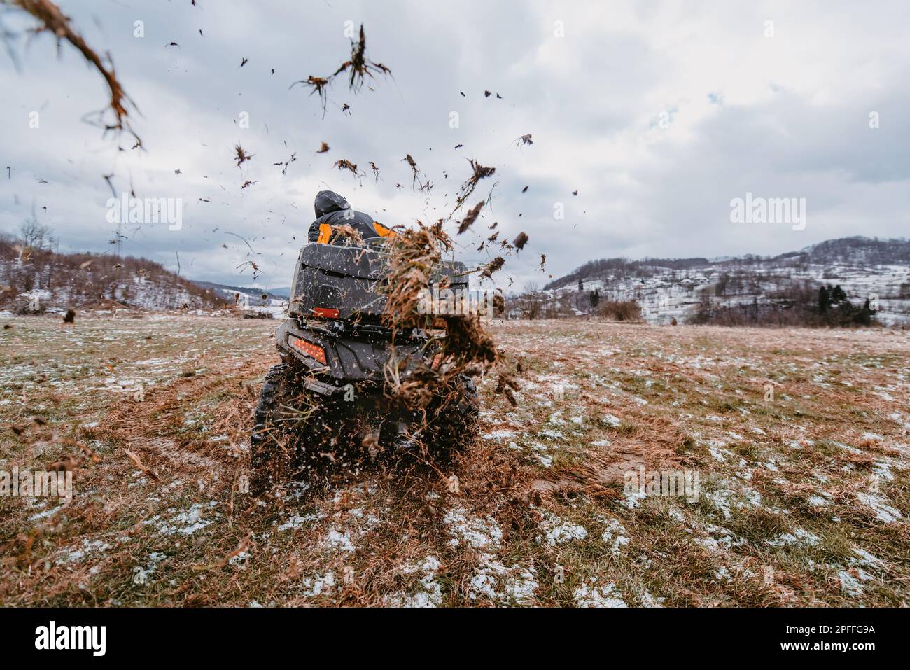 A man drives an ATV in the mud. Drift driving an ATV quad in mud and ...