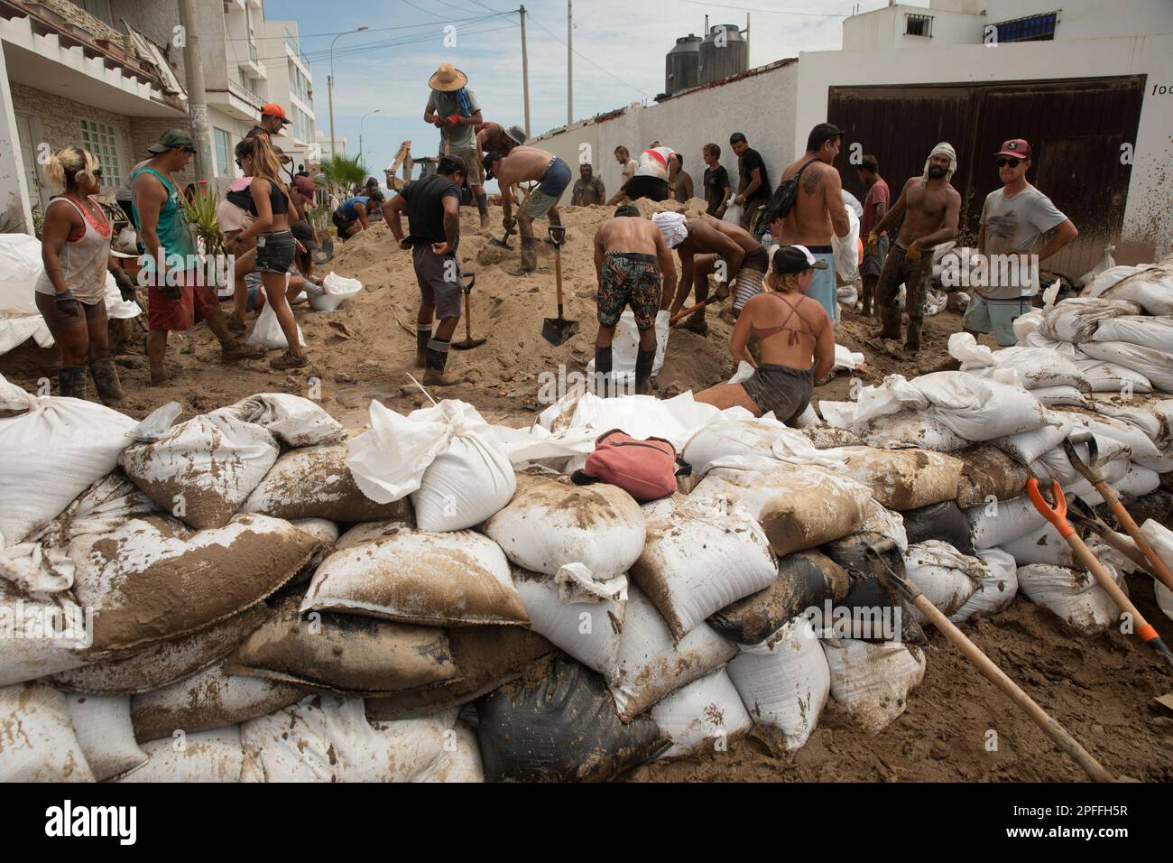 Lima, Peru. 16th Mar, 2023. People build a temporary barrier to prevent ...