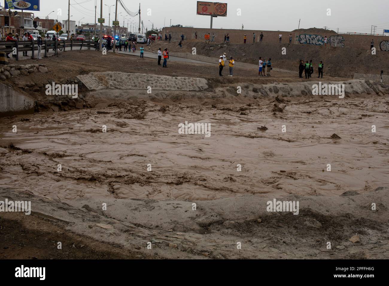 Lima, Peru. 14th Mar, 2023. People check on an area affected by ...