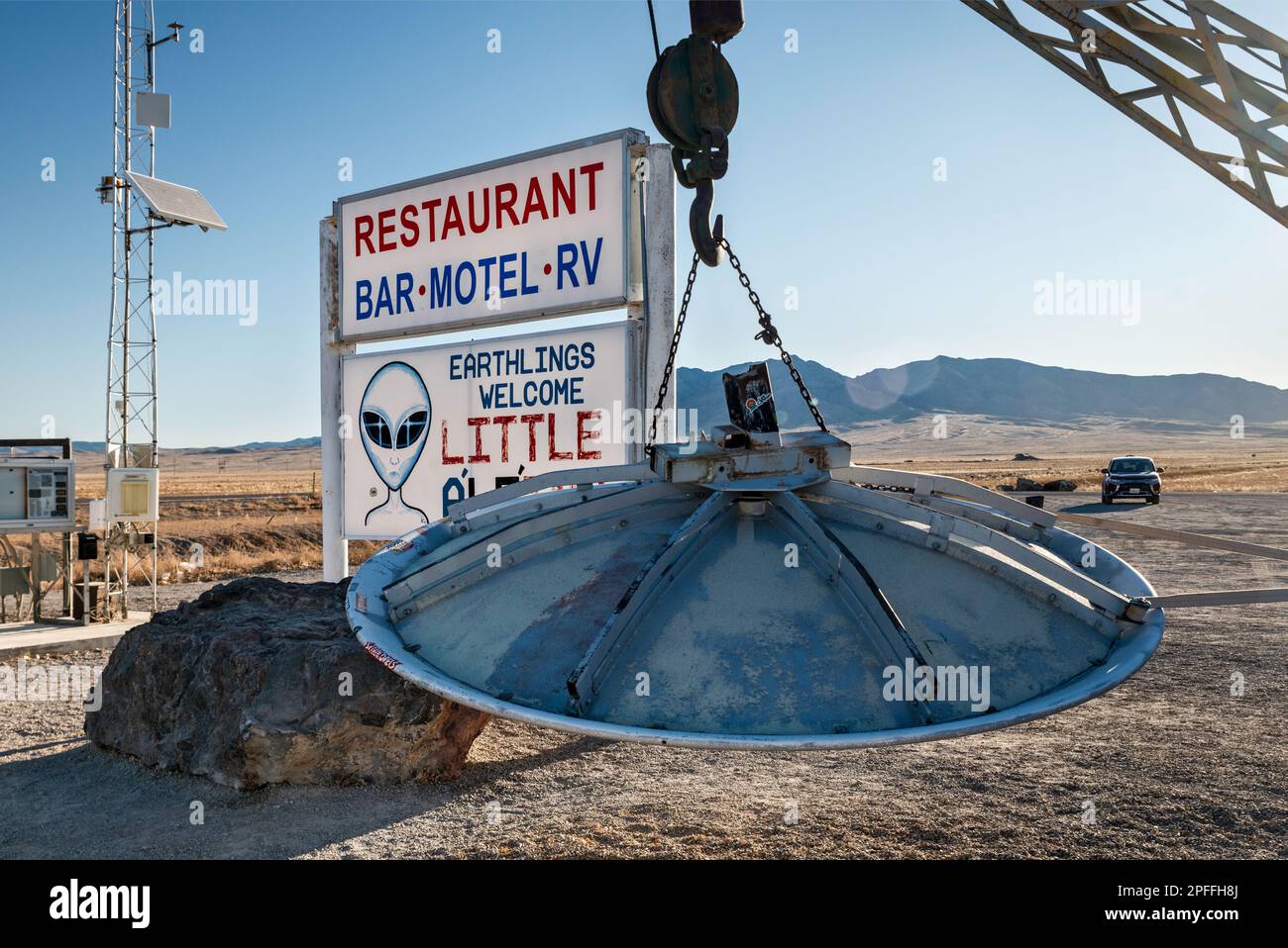 Crashed UFO, hanging on tow truck boom, local art installation, Little ...