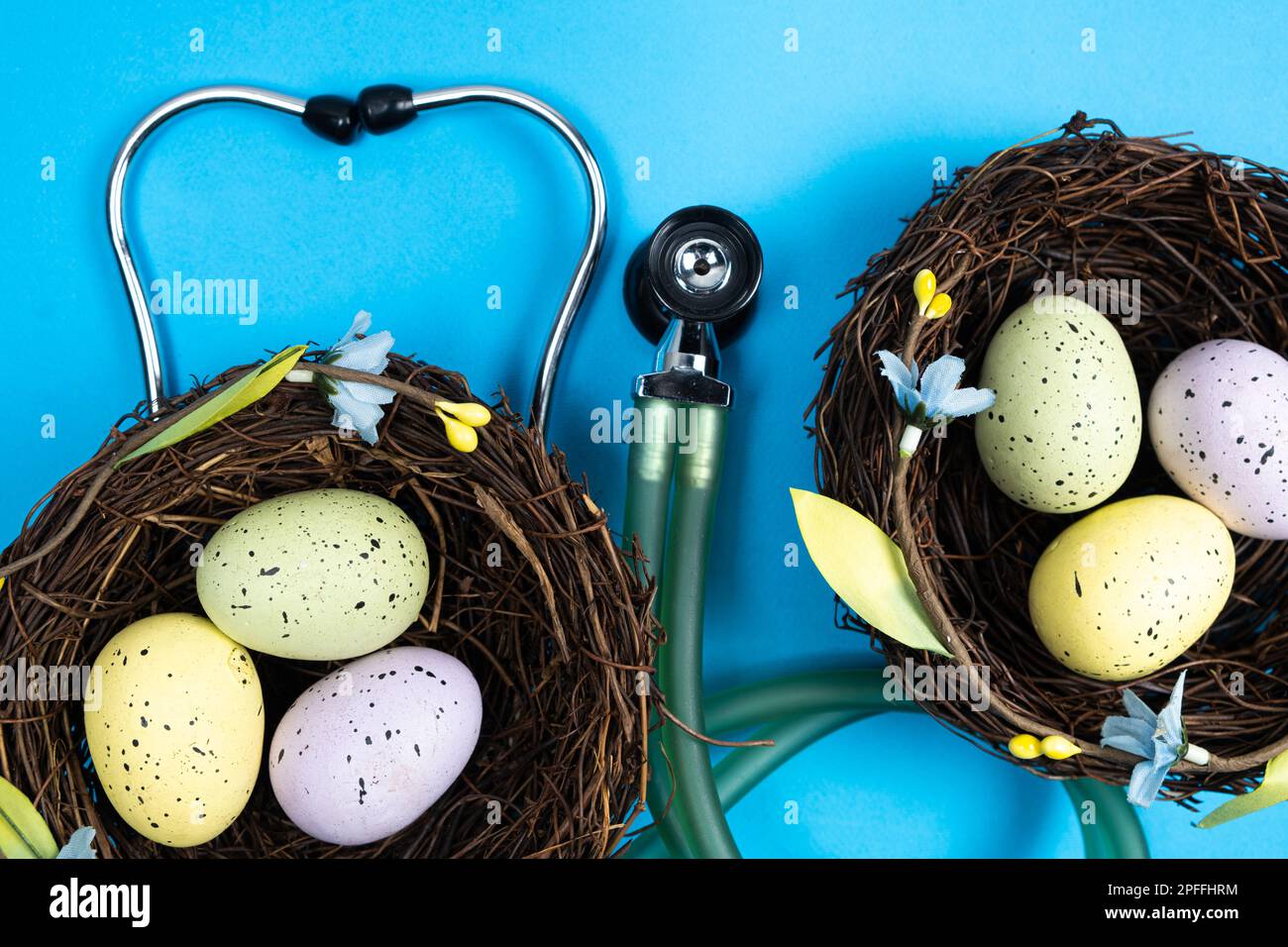 Easter Medicine. Two nests with painted eggs and a stethoscope on a ...