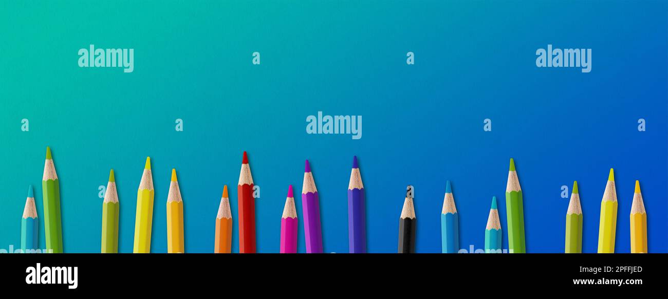 Wooden colored pencil set isolated on blue. Panoramic banner background ...