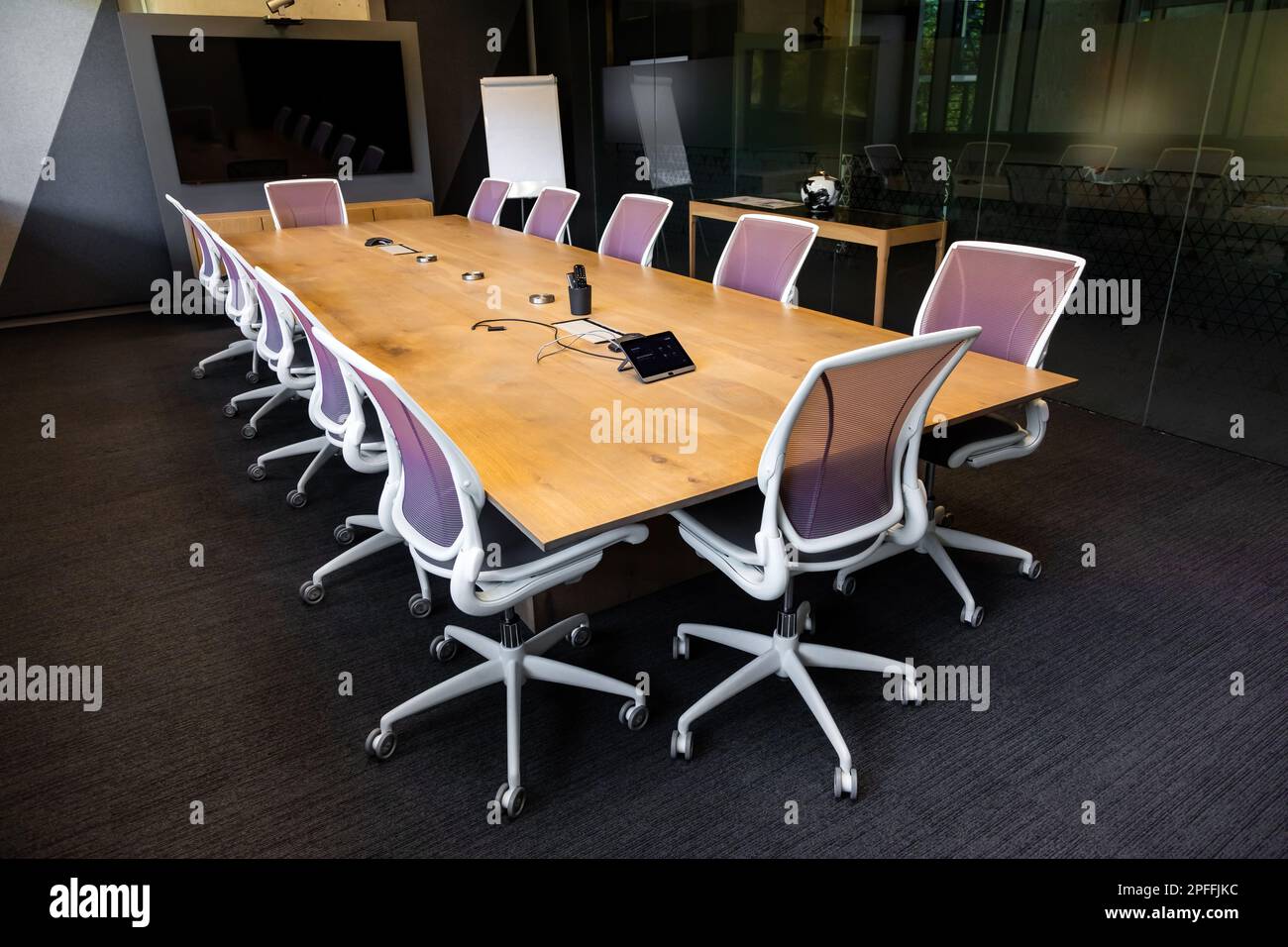 Empty executive boardroom with wooden table and fancy chairs on wheels ...