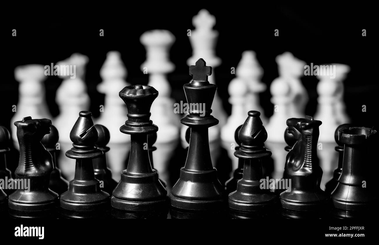 Close up of Chess pieces on a reflective mirror board surface with a ...