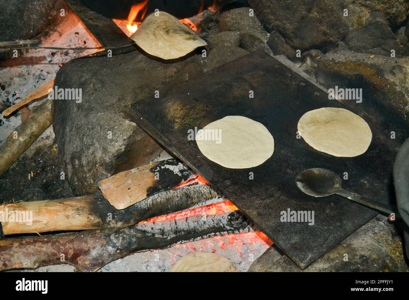 Traditional way of cooking in India. Preparing food in open fire in the ...