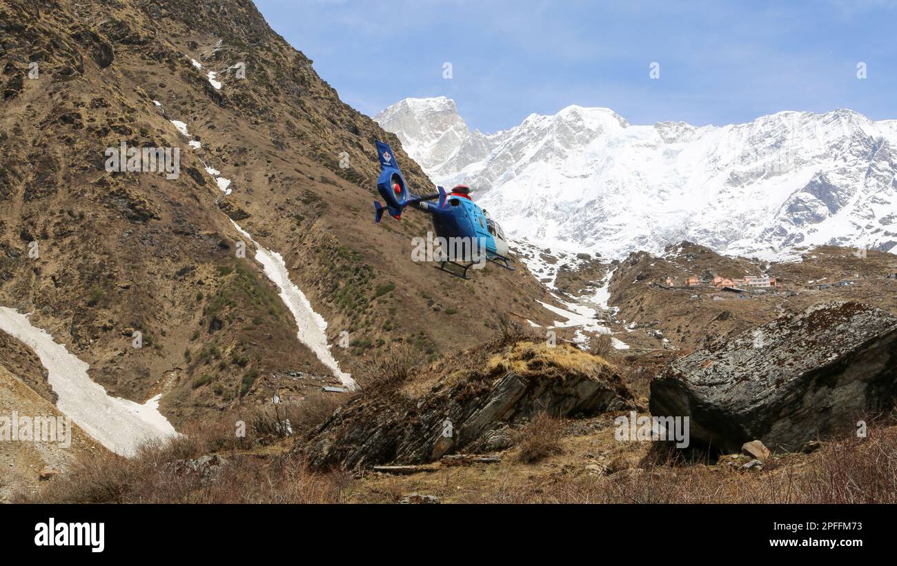 A Helicopter in the valley of Kedarnath in India. Kedarnath Temple is a ...