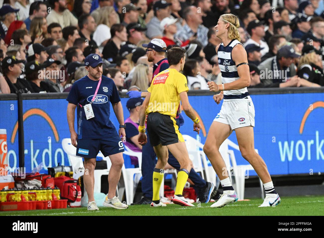 Sam De Koning of Geelong (right) exits the field during the AFL Round 1 ...