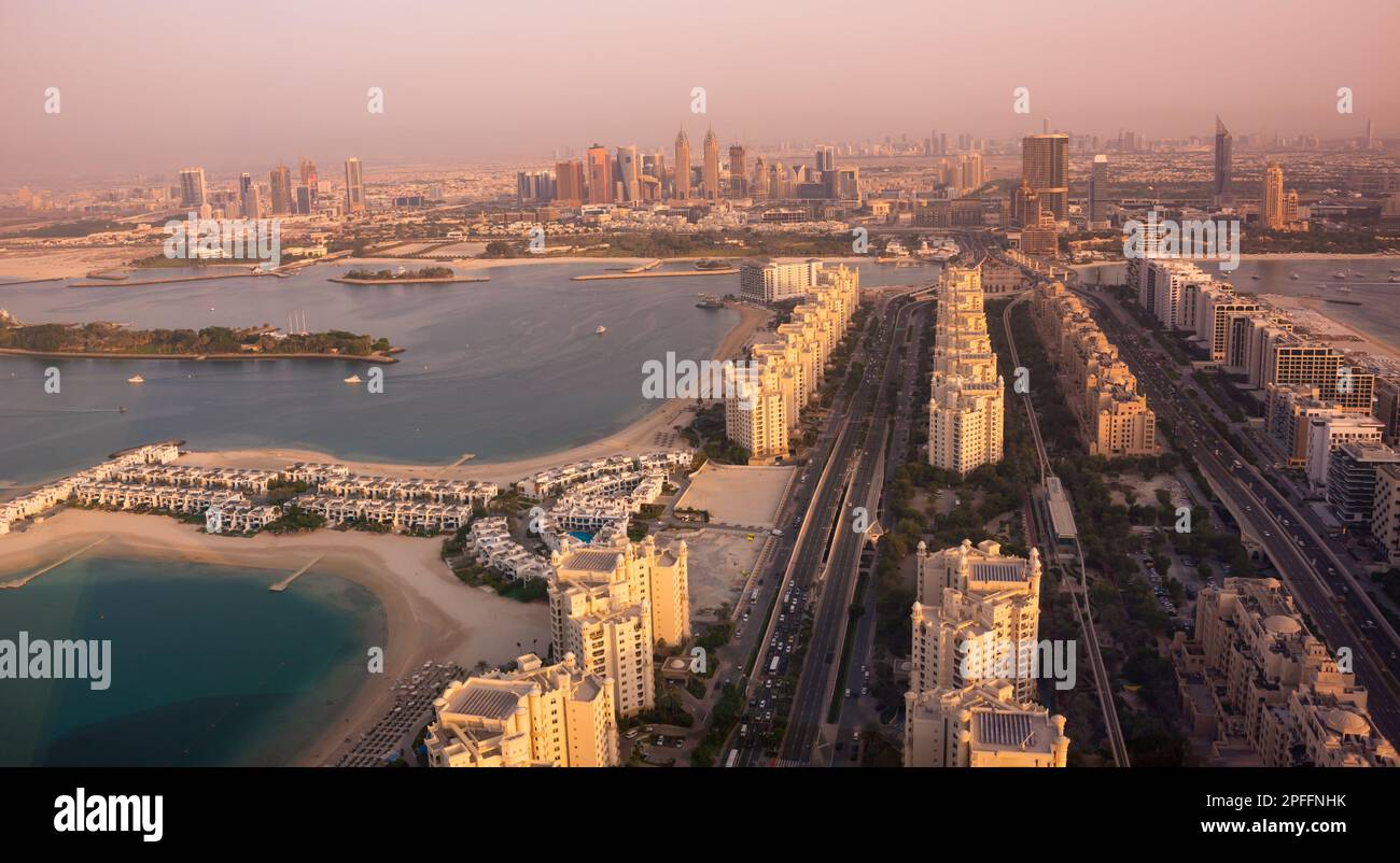 Dubai skyline on sunset, modern city with skyscrapers seen from water ...