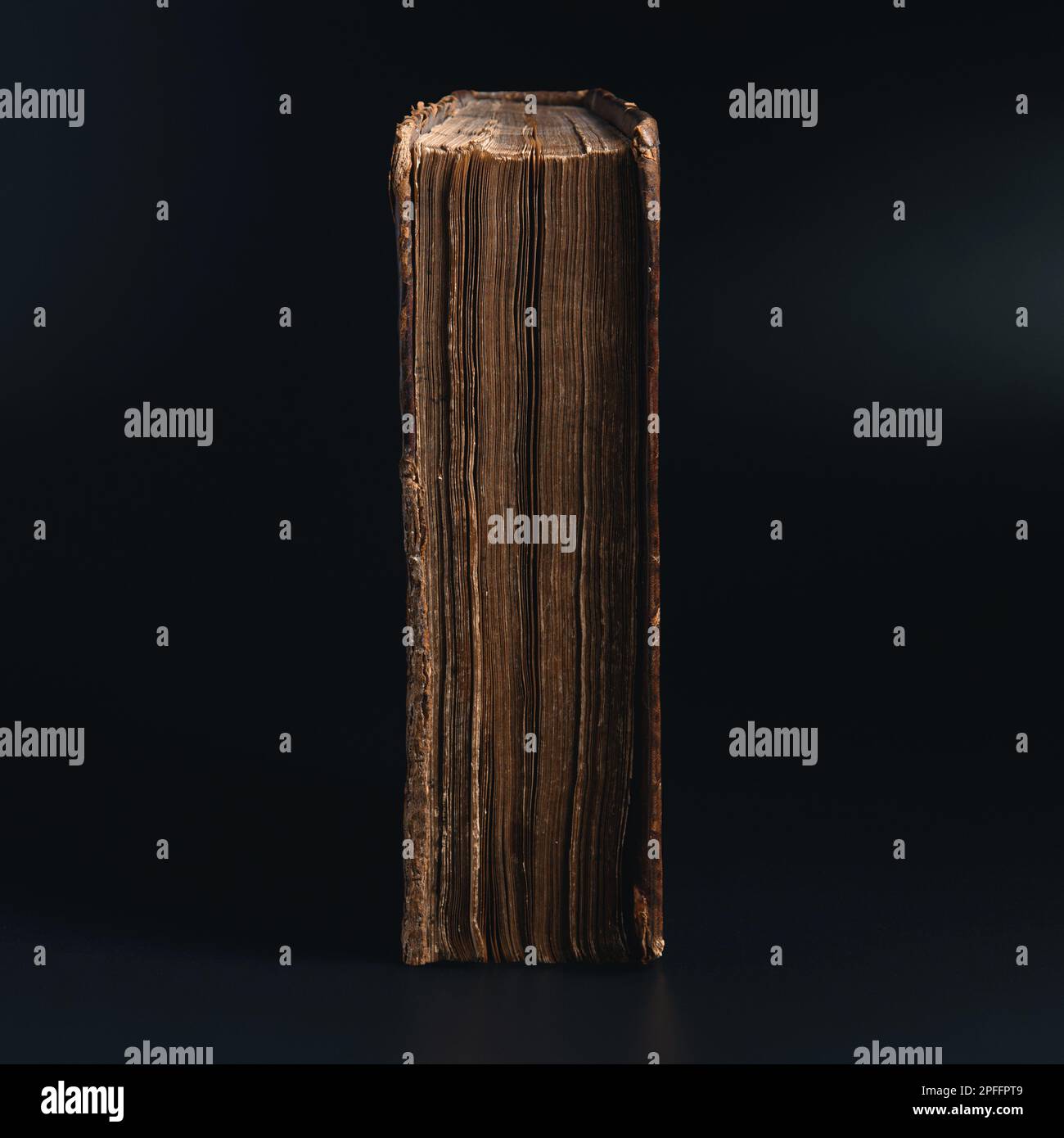 Fore edge of old worn book pages on black background. Torah book ...
