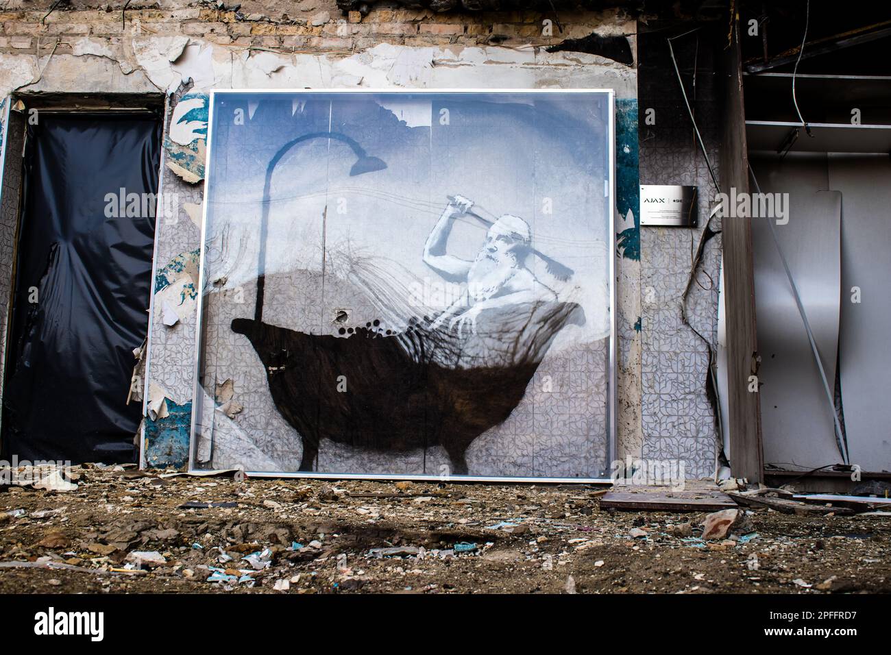 Mural by Banksy in Gorenka, a bearded man bathing on a ruined building ...