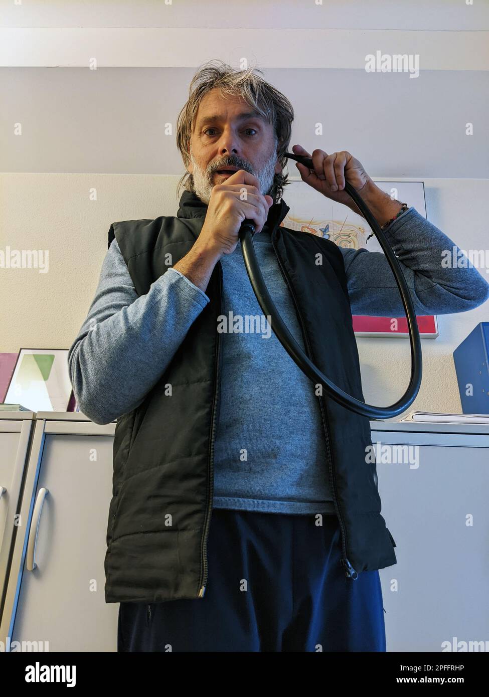 Deaf concept, caucasian man with vintage device in the office Stock ...