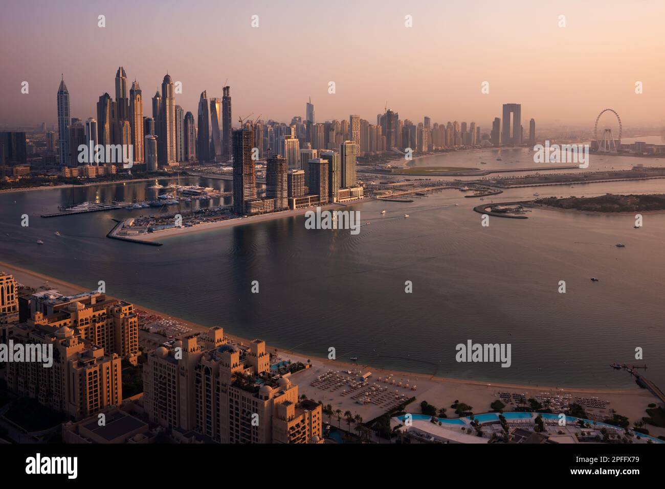 Dubai skyline on sunset, modern city with skyscrapers seen from water ...