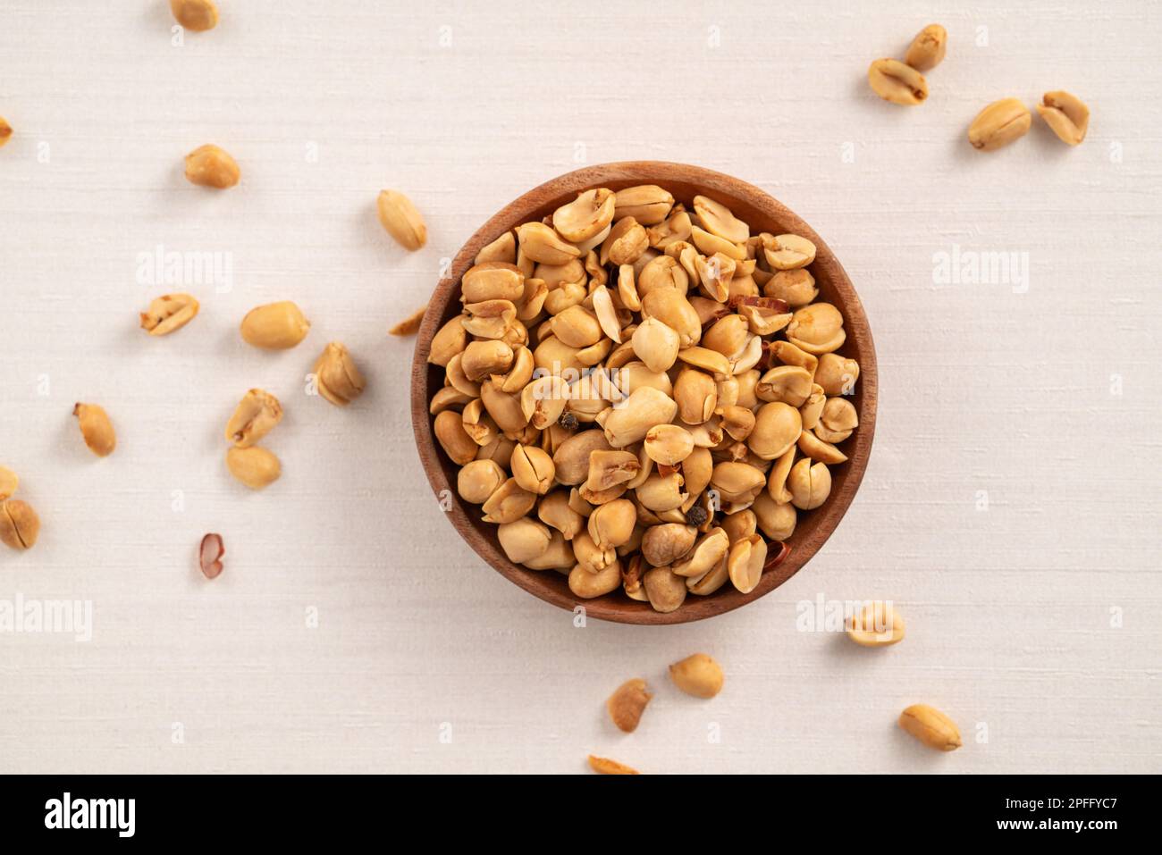 Spicy flavored peanut kernel in a bowl on white table background Stock ...