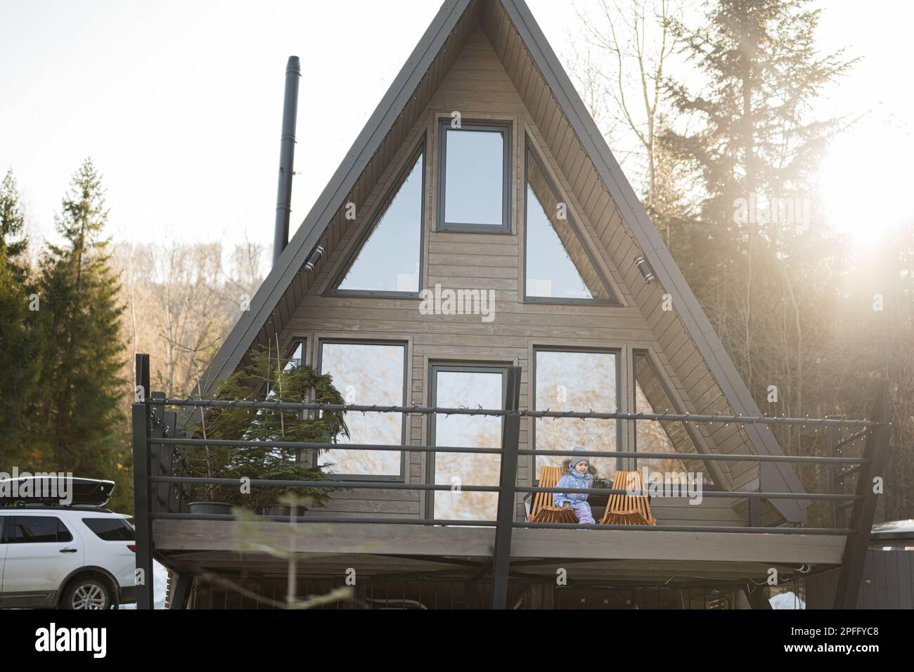 Baby girl sit on terrace off grid tiny house in the mountains Stock ...