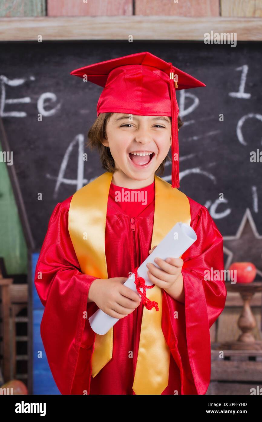 An adorable little boy proudly displaying a VPK diploma during ...