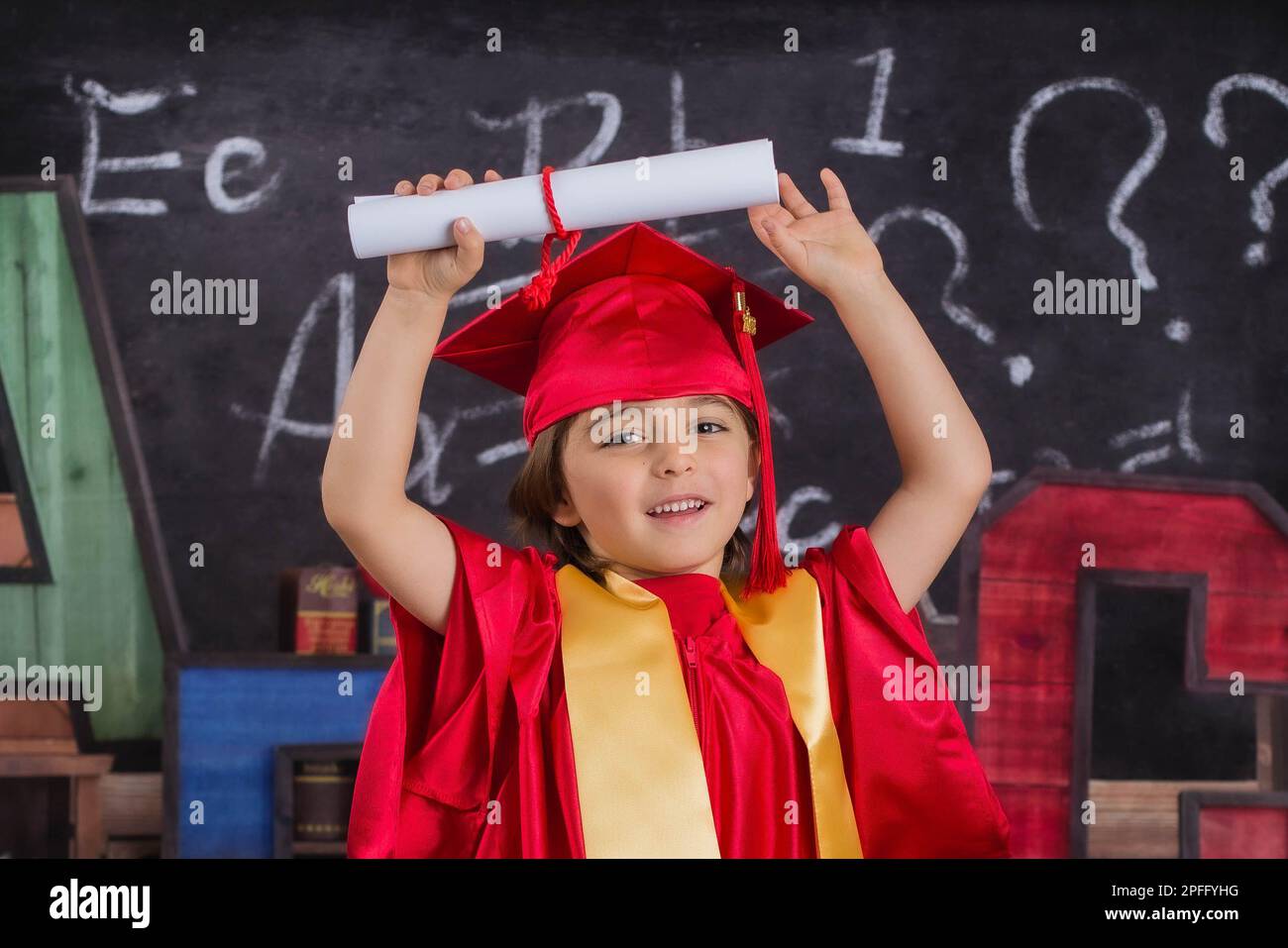 An adorable little boy proudly displaying a VPK diploma during ...