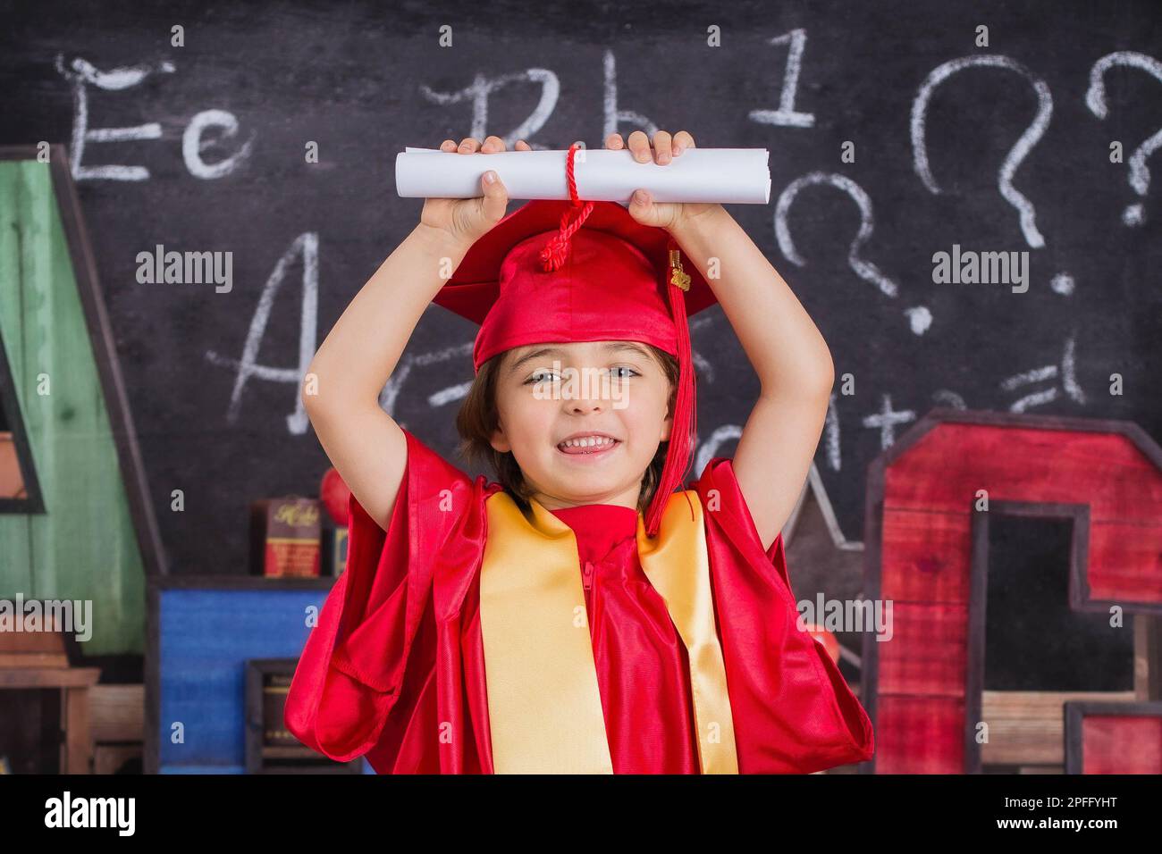 An adorable little boy proudly displaying a VPK diploma during ...