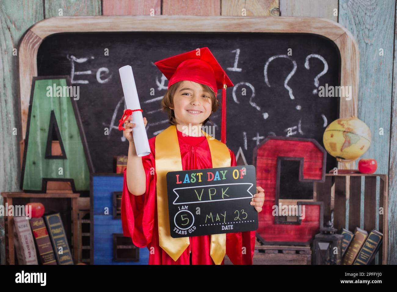 An adorable little boy proudly displaying a VPK diploma during ...