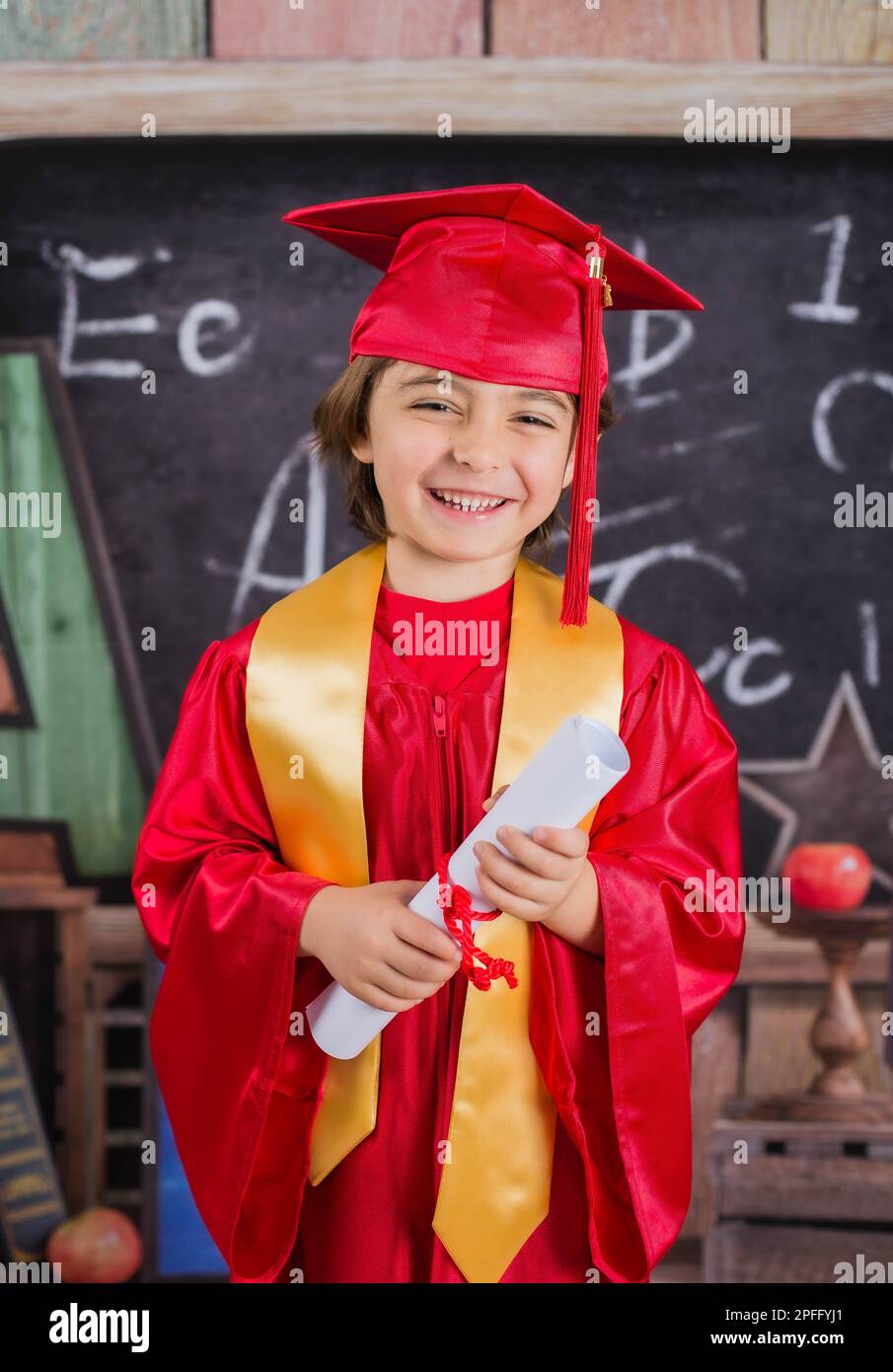 An adorable little boy proudly displaying a VPK diploma during ...