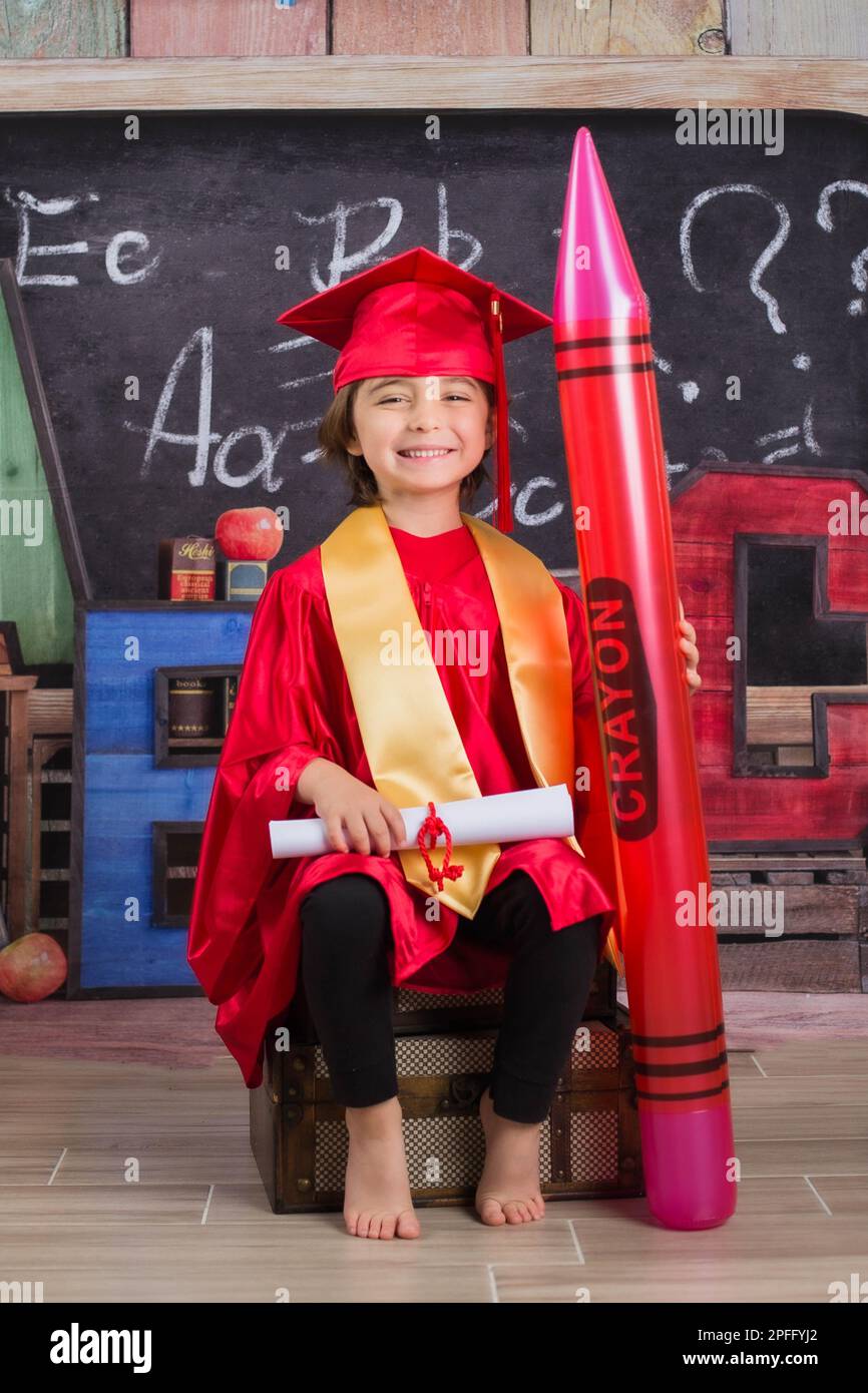 An adorable little boy proudly displaying a VPK diploma during ...