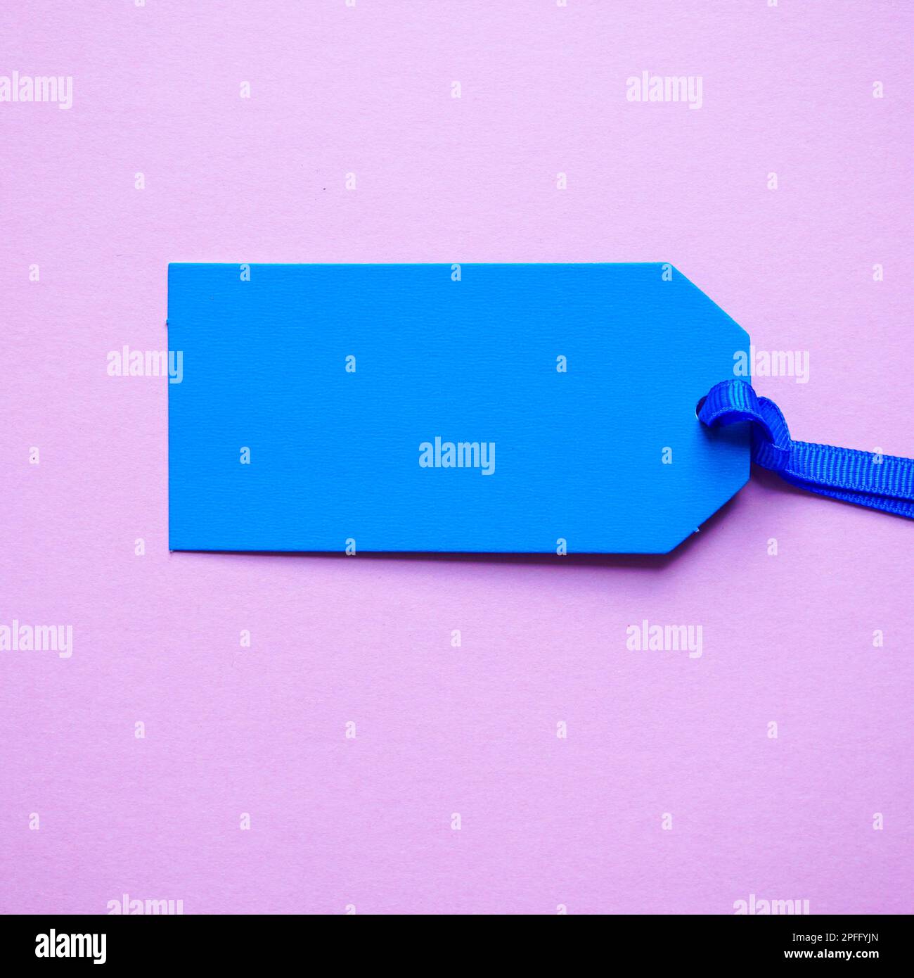 blue price tag on the pink background Stock Photo - Alamy