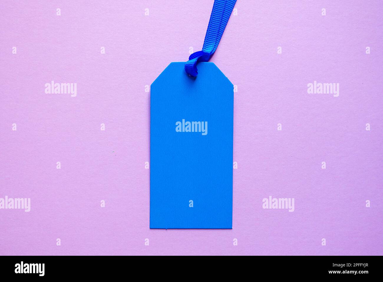blue price tag on the pink background Stock Photo - Alamy
