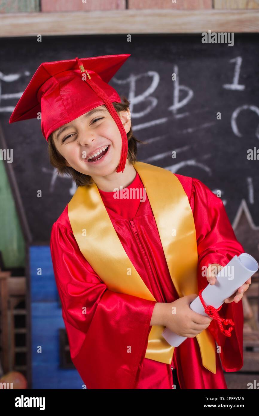 An adorable little boy proudly displaying a VPK diploma during ...