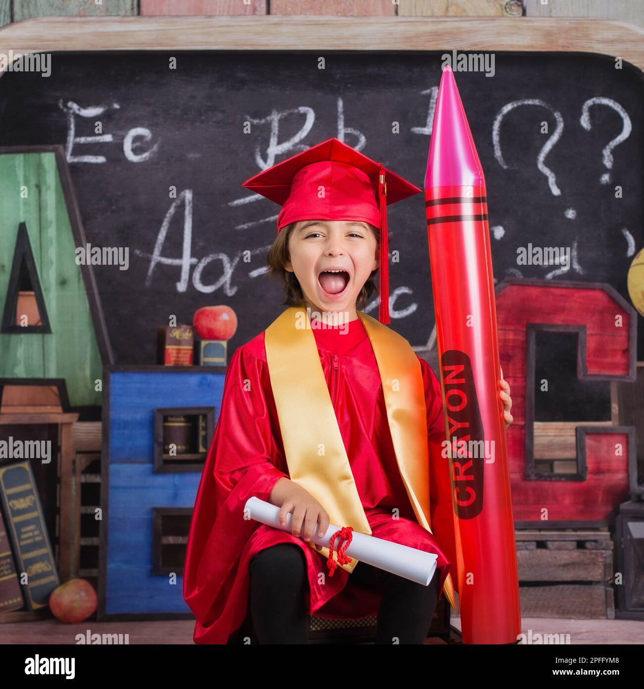 An adorable little boy proudly displaying a VPK diploma during ...