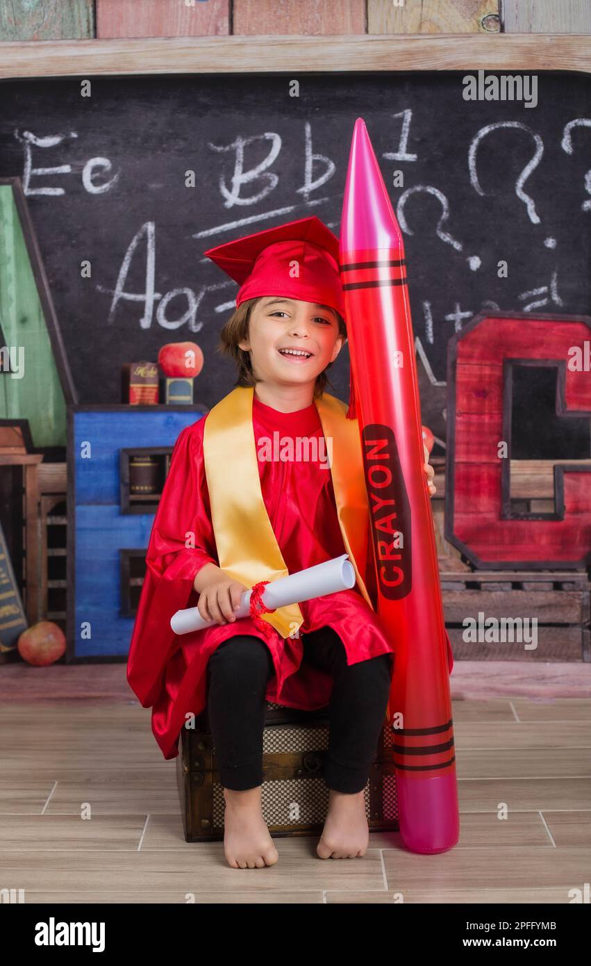 An adorable little boy proudly displaying a VPK diploma during ...