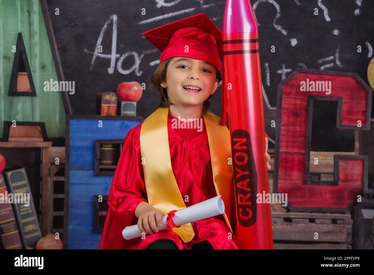 An adorable little boy proudly displaying a VPK diploma during ...