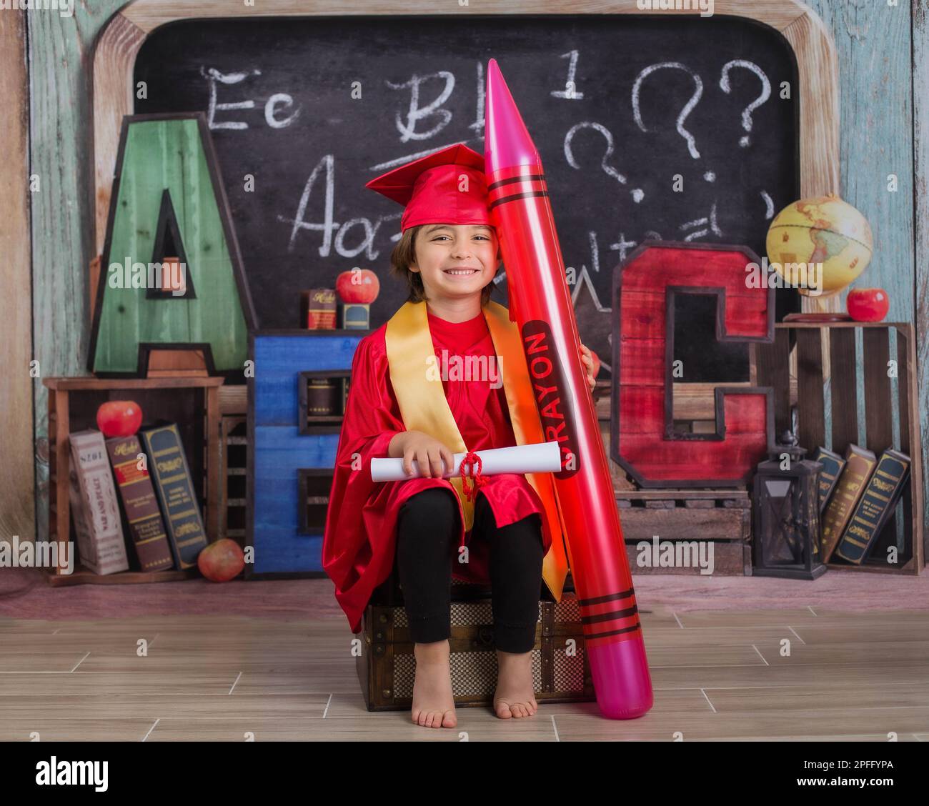 An adorable little boy proudly displaying a VPK diploma during ...