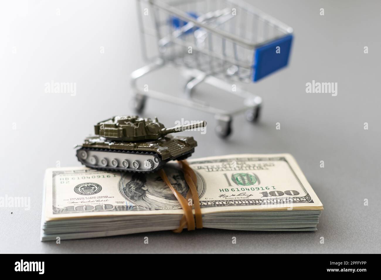 a toy tank, dollars and a cart Stock Photo - Alamy