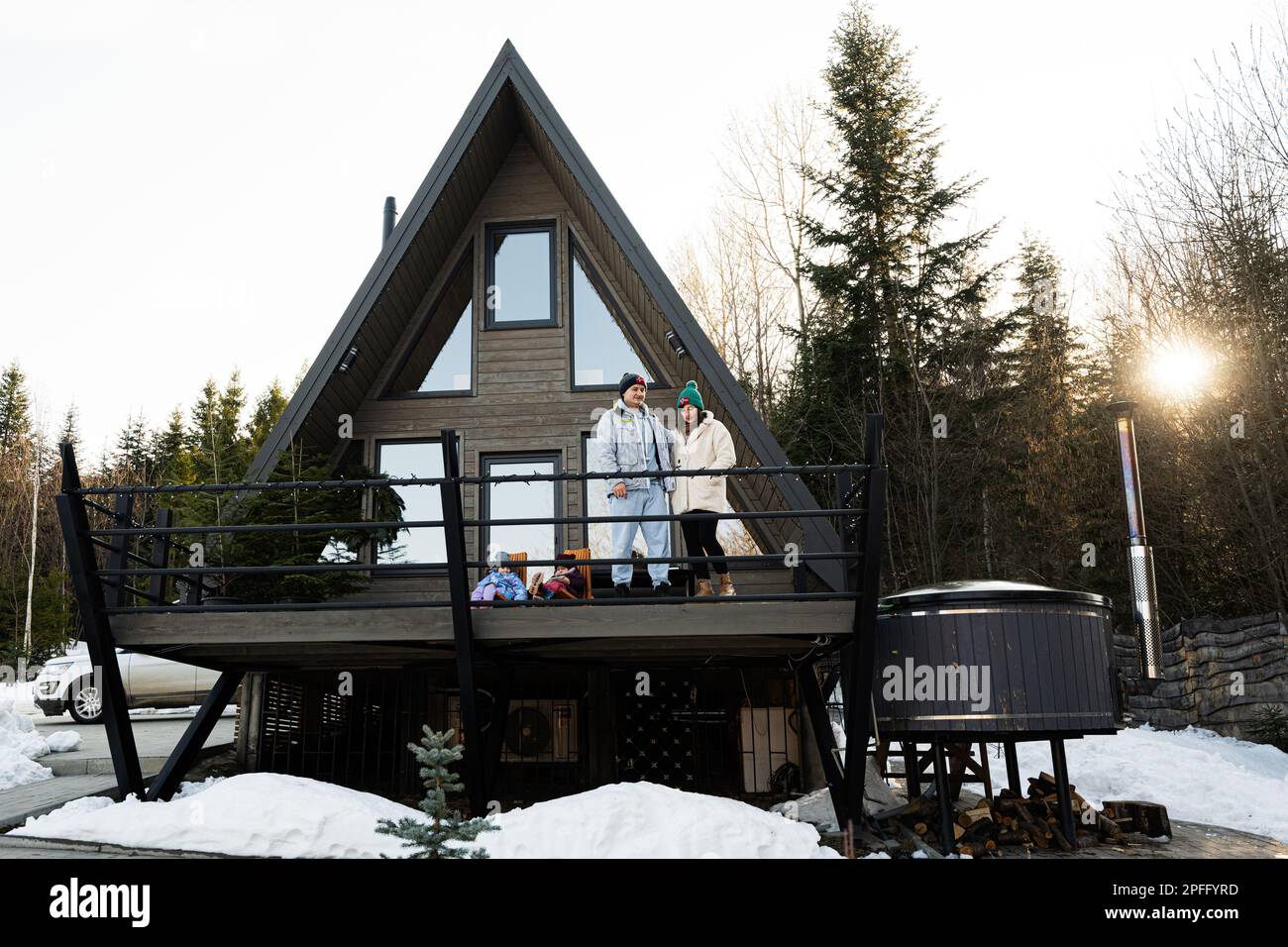 Family with two daughters on terrace off grid tiny house in the ...