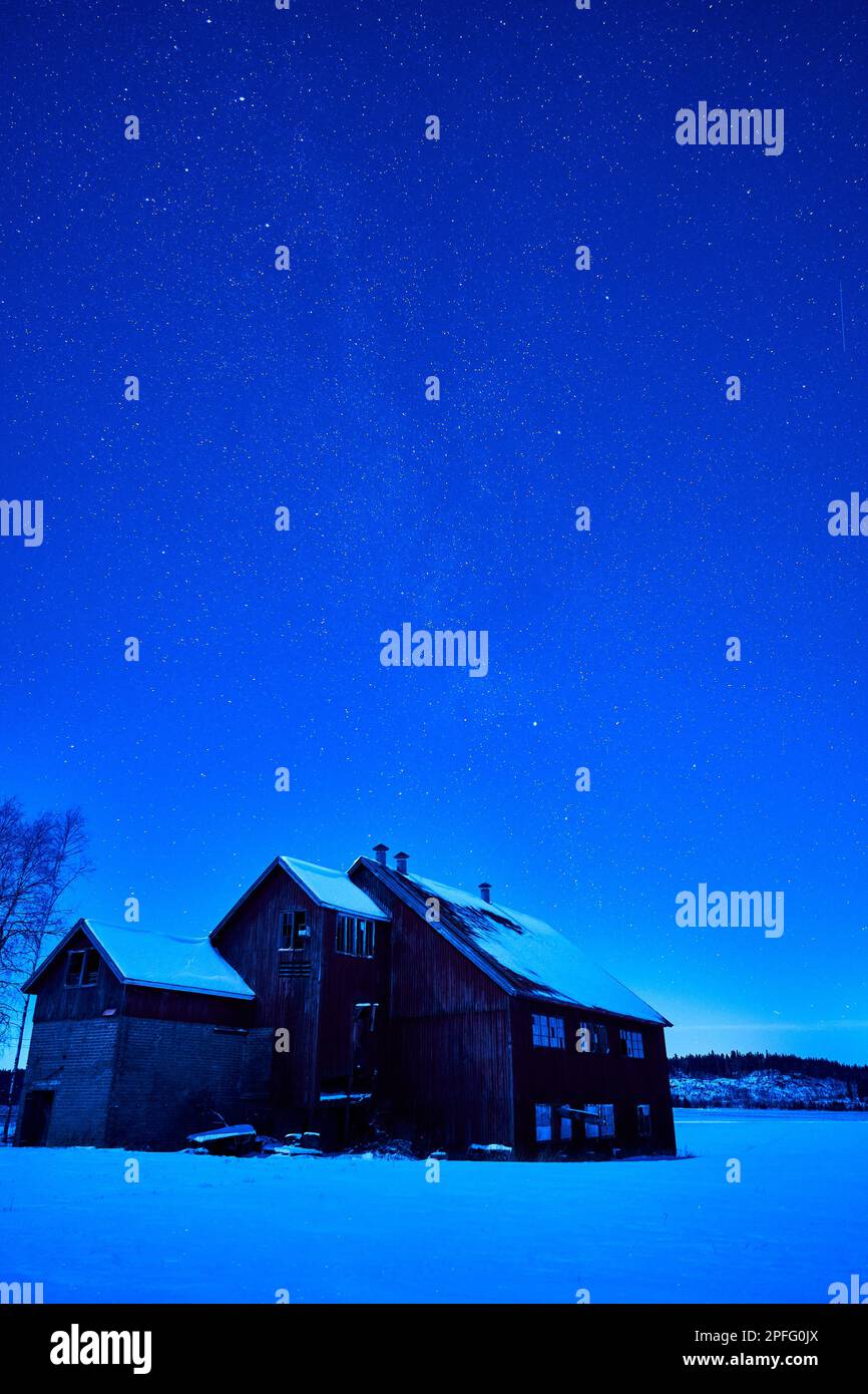 An idyllic winter scene of a converted building with starry night sky ...