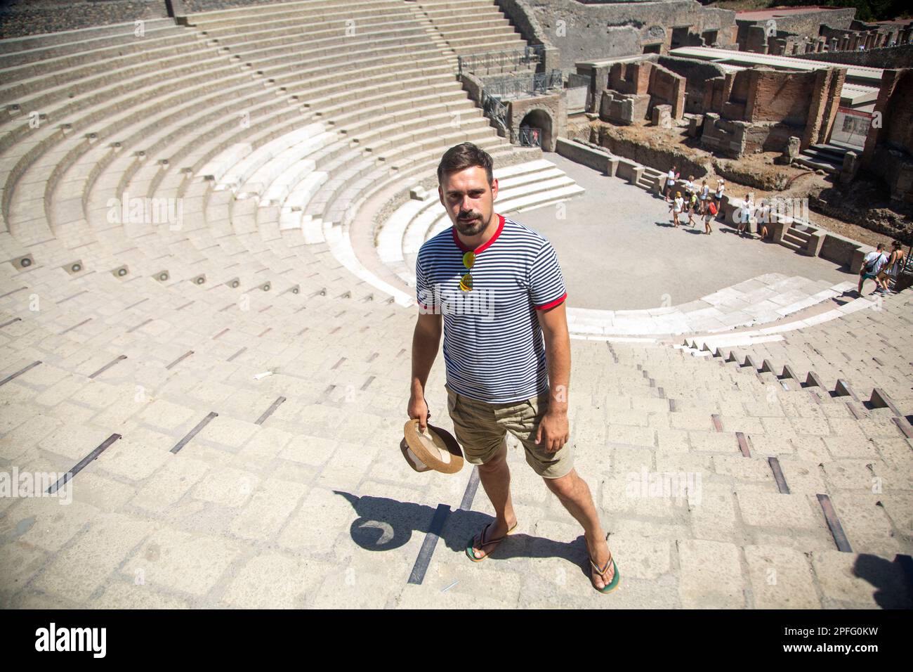 A man stands on a roman amphitheater in the ancient city of Pompei, the ...