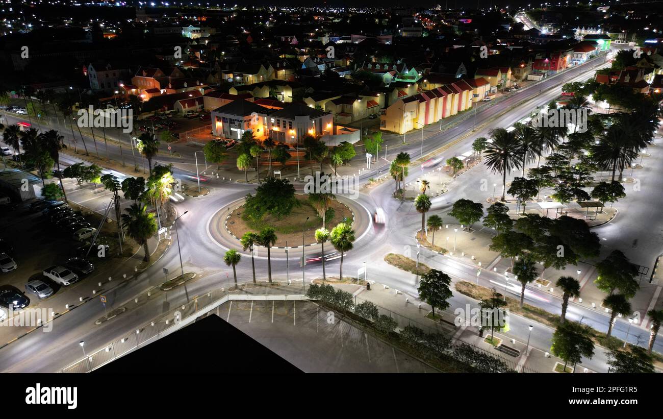 An aerial view of an intersection illuminated by street-lights, with ...