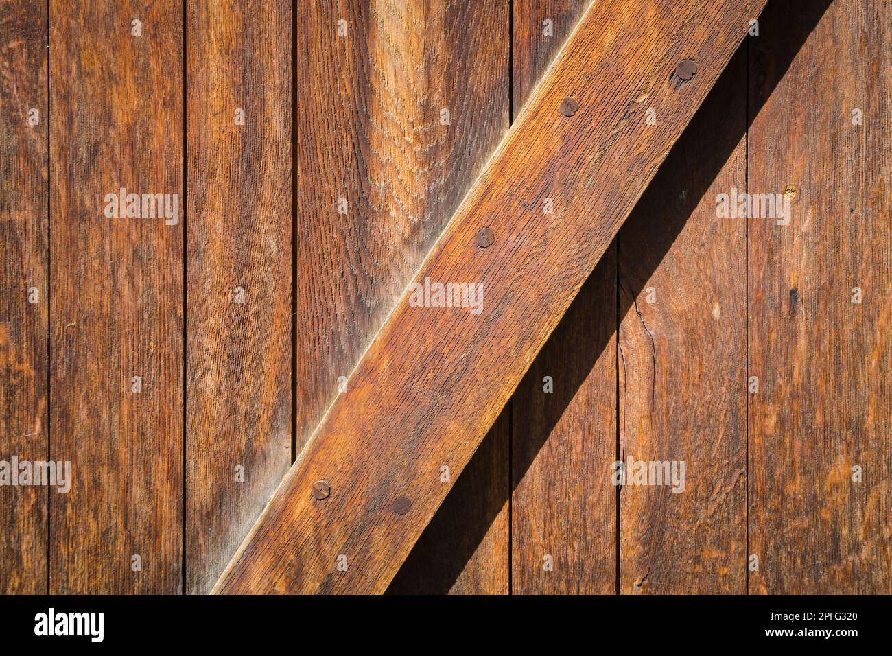 Detail of old unpainted wooden door with vertical slats and one ...