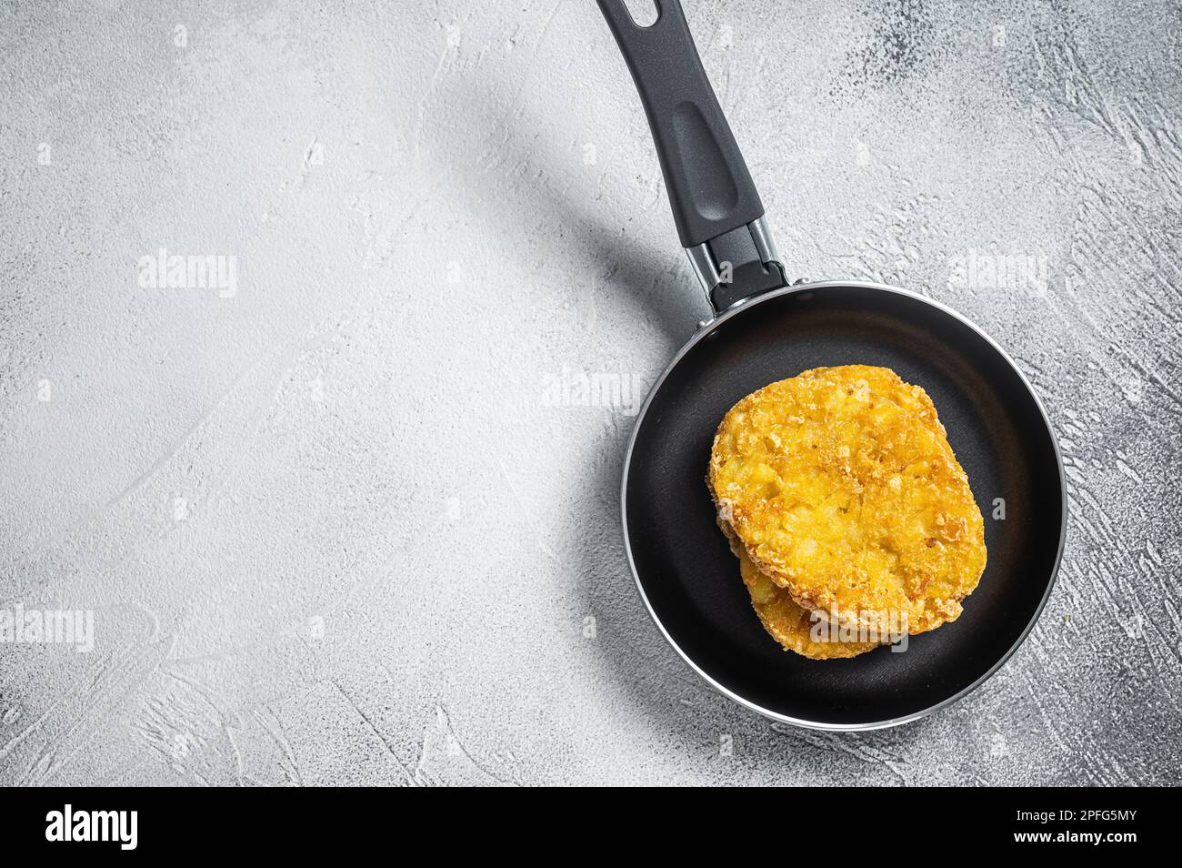 Fried Hash brown potato, hashbrown fritters in a skillet. White ...