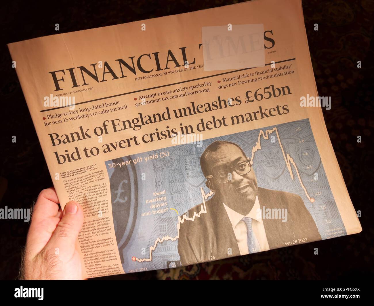 United Kingdom - Oct 21, 2022: A hand holding a copy of the Financial ...