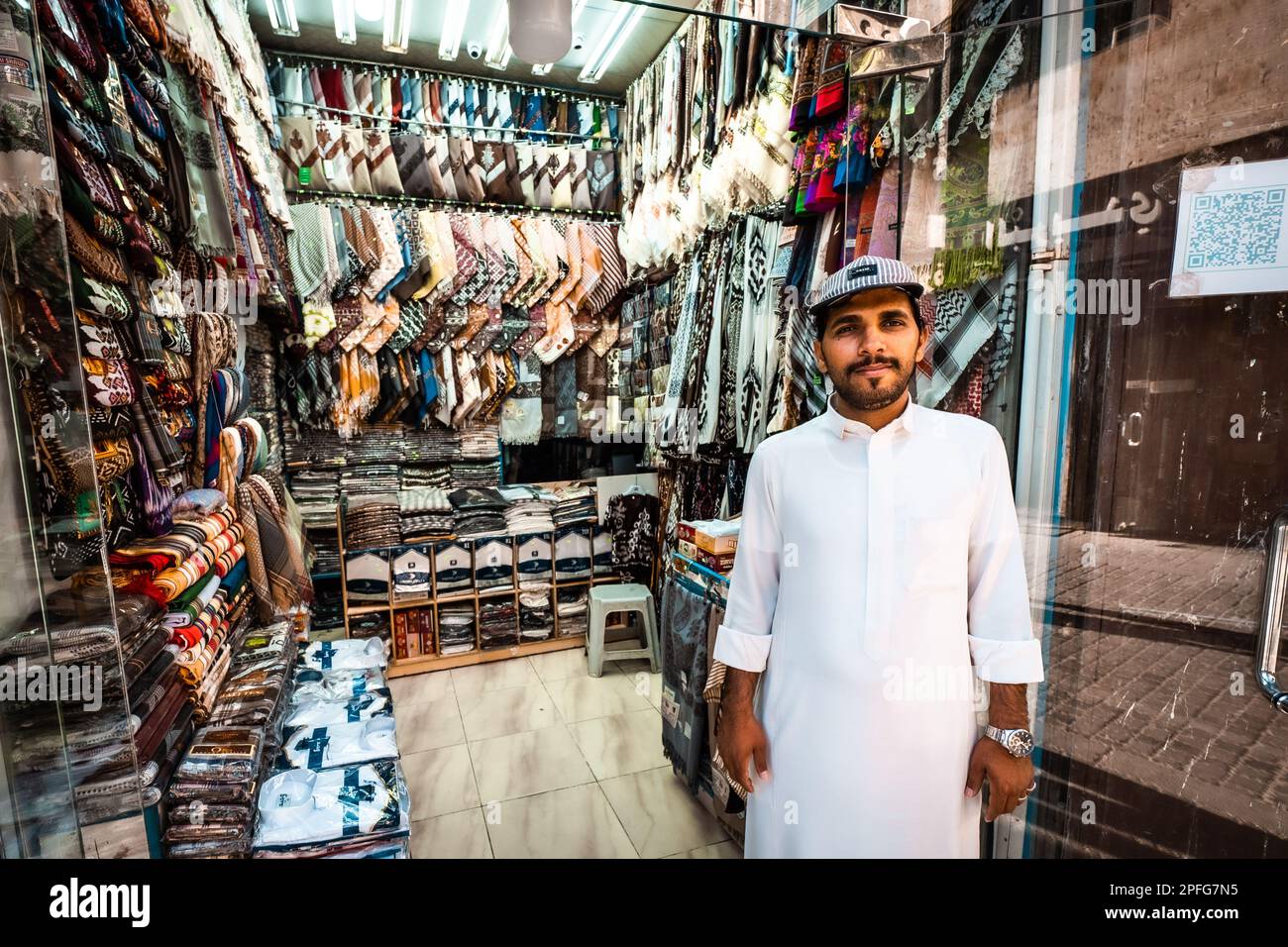 Portrait of proud textiles salesman in his shop at Souk Baab Makkah ...