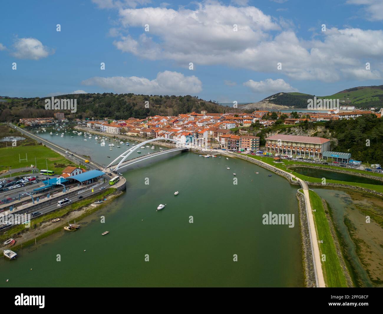 An idyllic rural landscape with a small village nestled on the banks of ...