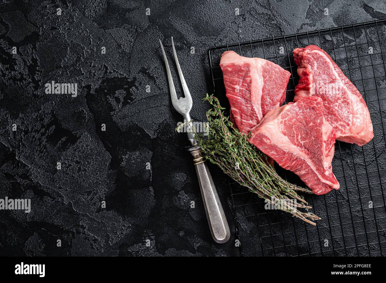 Topside sirloin beef cut, raw meat with spices. Black background. Top ...