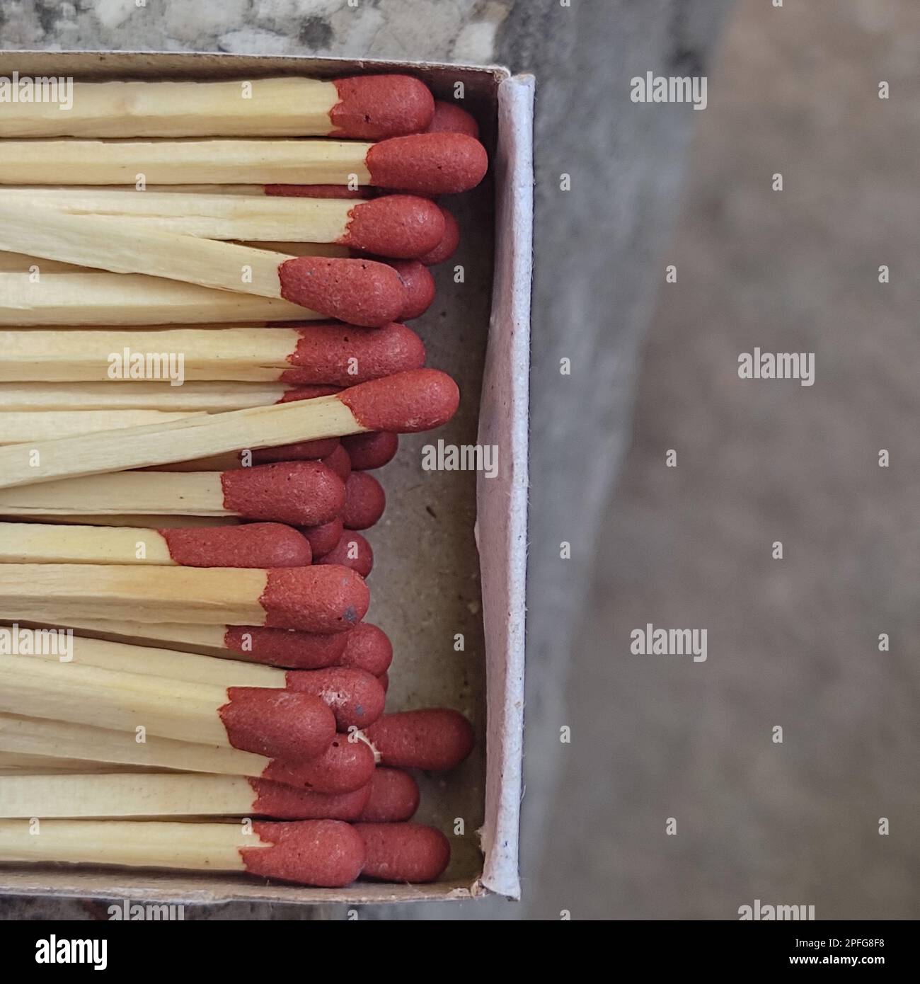 Close up of open single cardboard match box on granite stone background ...