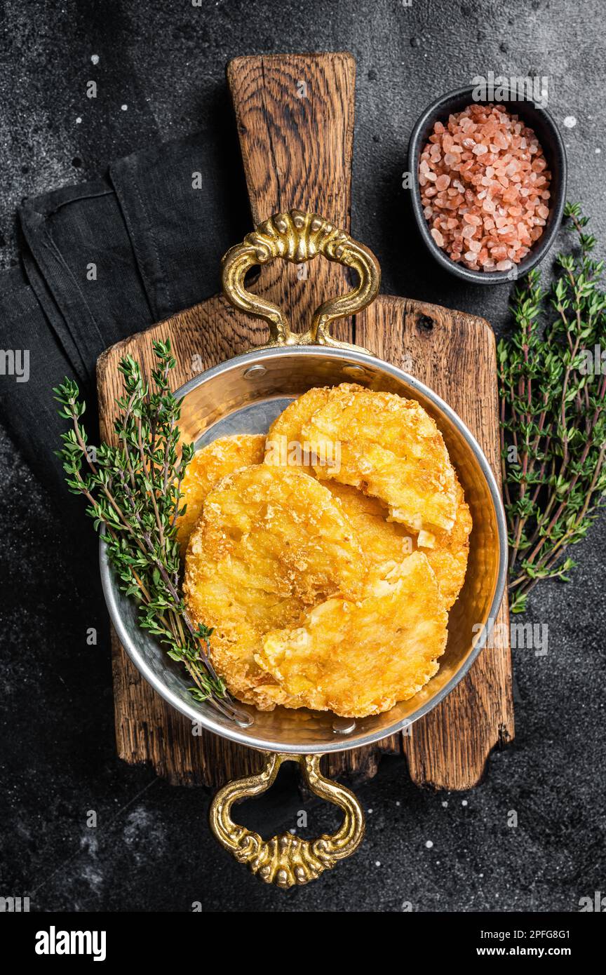 Fried Hash brown potato, hashbrown in a skillet. Black background. Top ...