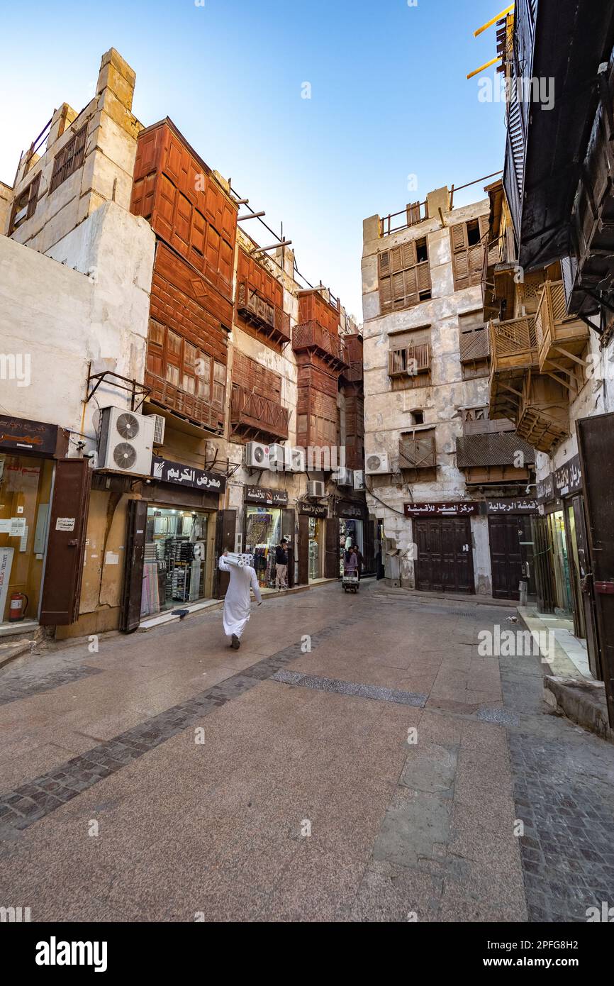 View of a small square surrounded by tall traditional coral townhouses ...