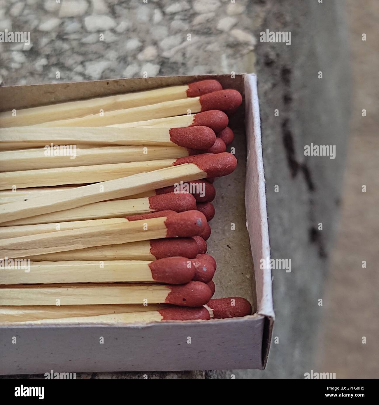 Close up of open single cardboard match box on granite stone background ...