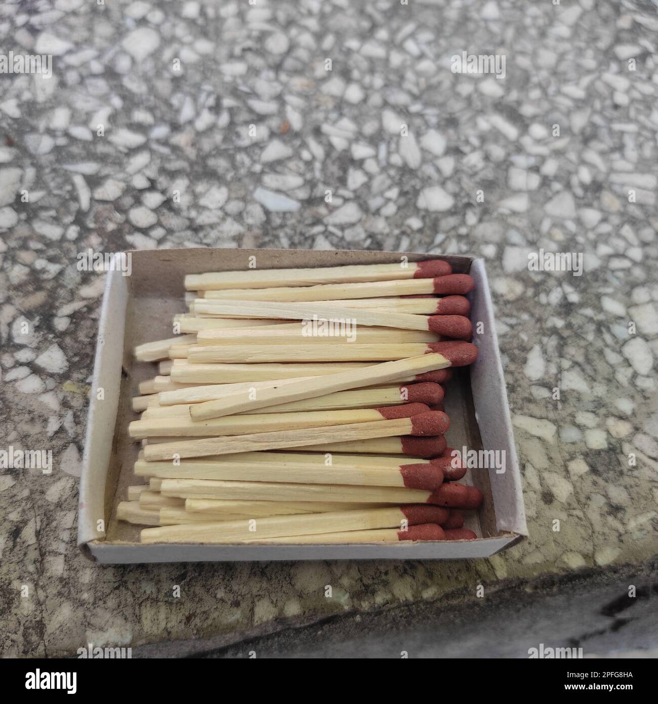 Close up of open single cardboard match box on granite stone background ...