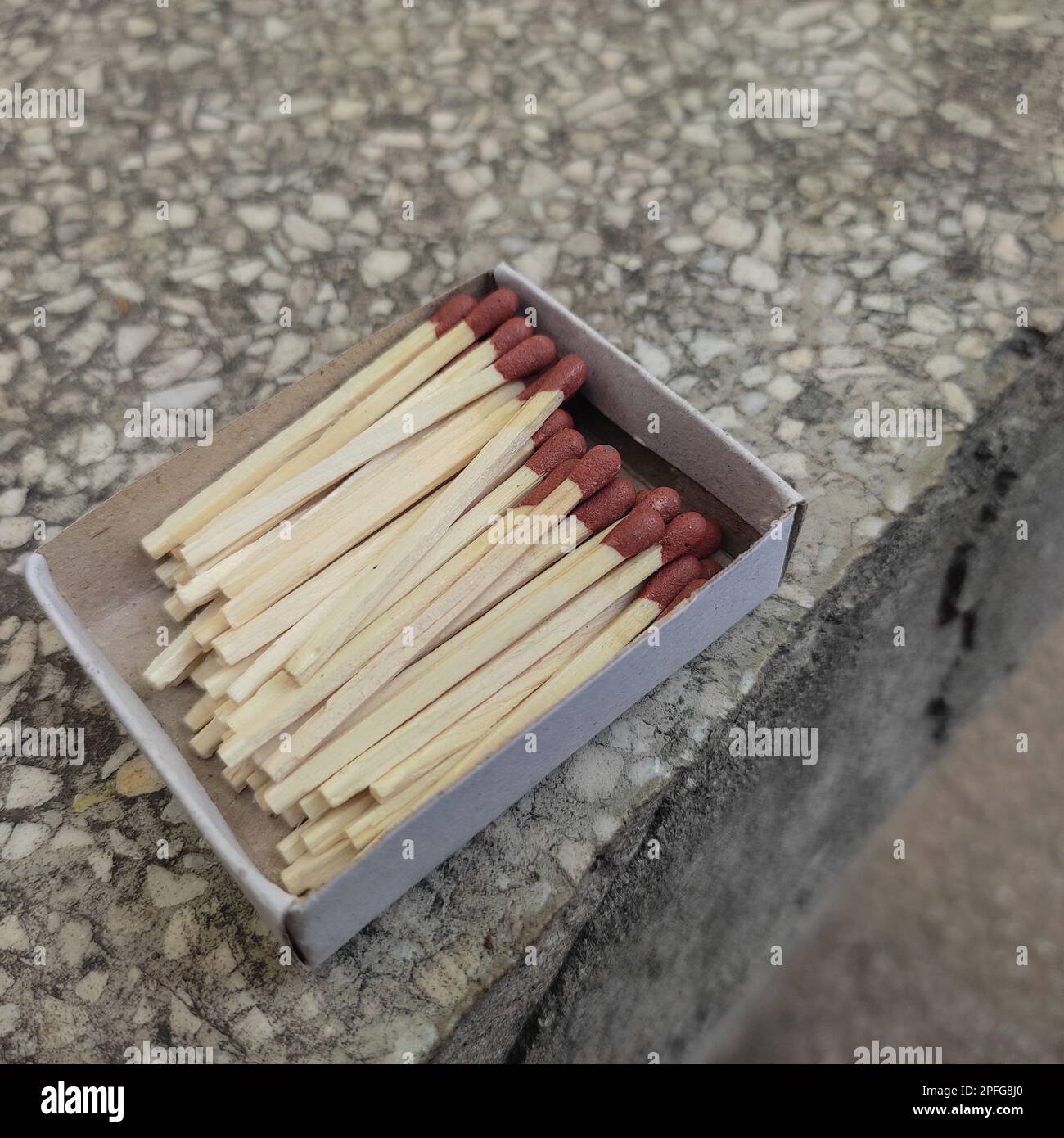 Close up of open single cardboard match box on granite stone background ...