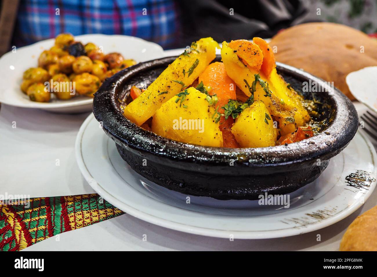 Tajine or tagine - traditional Berber dish served in black earthenware ...