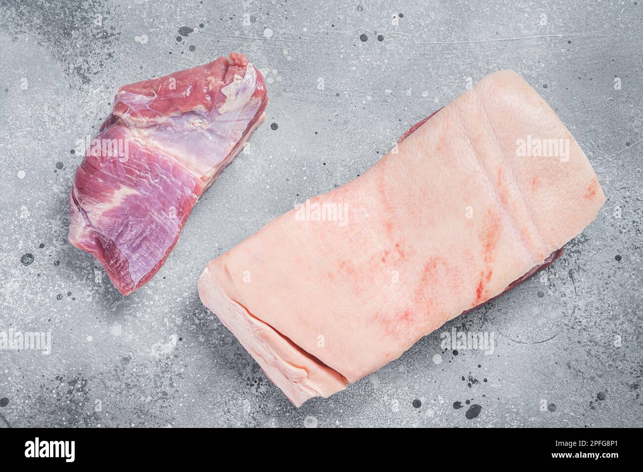 Raw pork belly with skin on a butcher table. Gray background. Top view ...